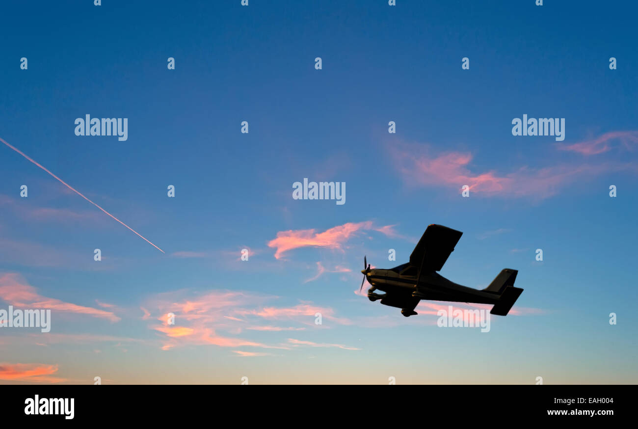 single engine airplane flying at sunset Stock Photo - Alamy