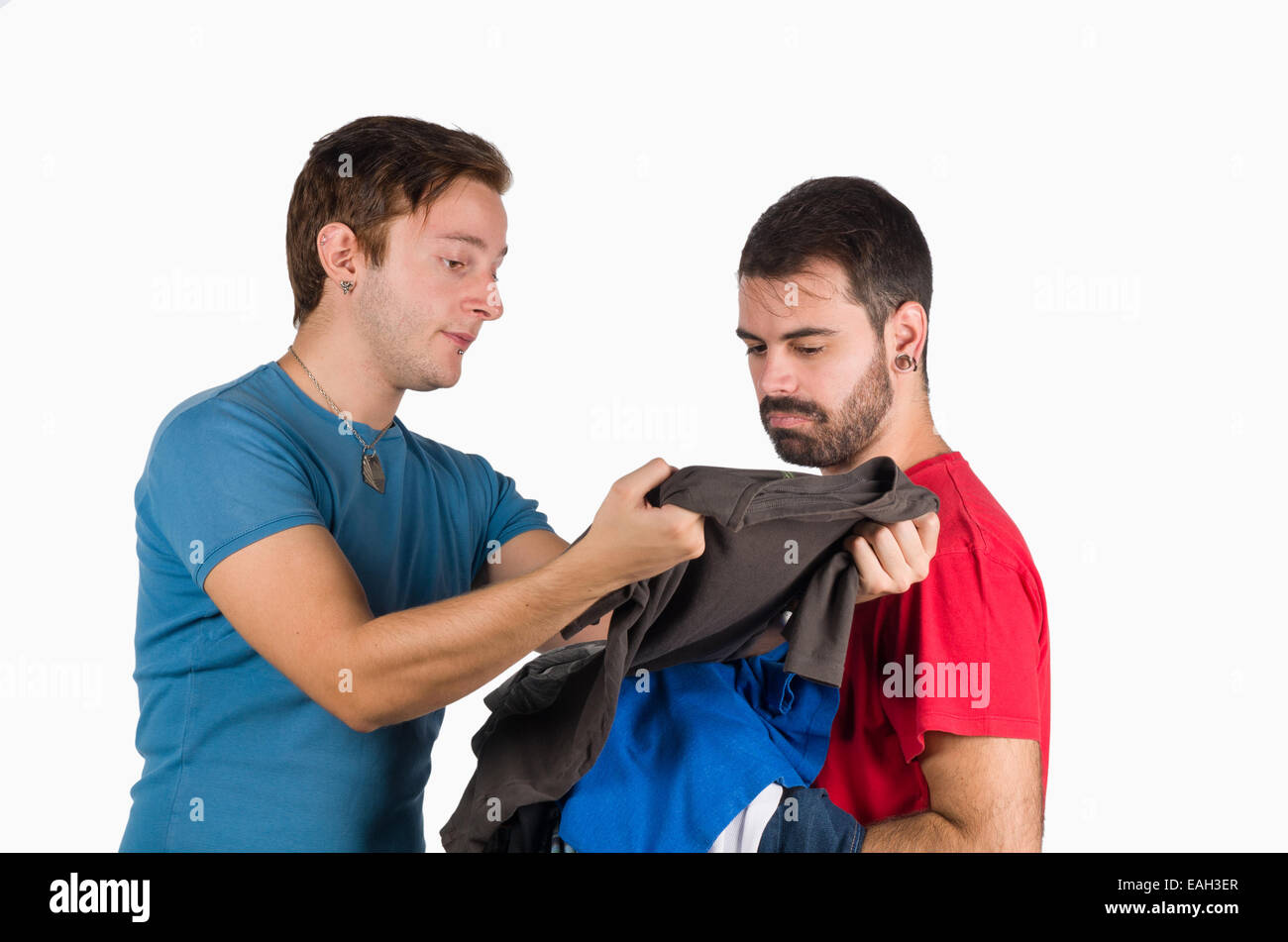 Guy being pretty choosy and dainty about clothes Stock Photo - Alamy