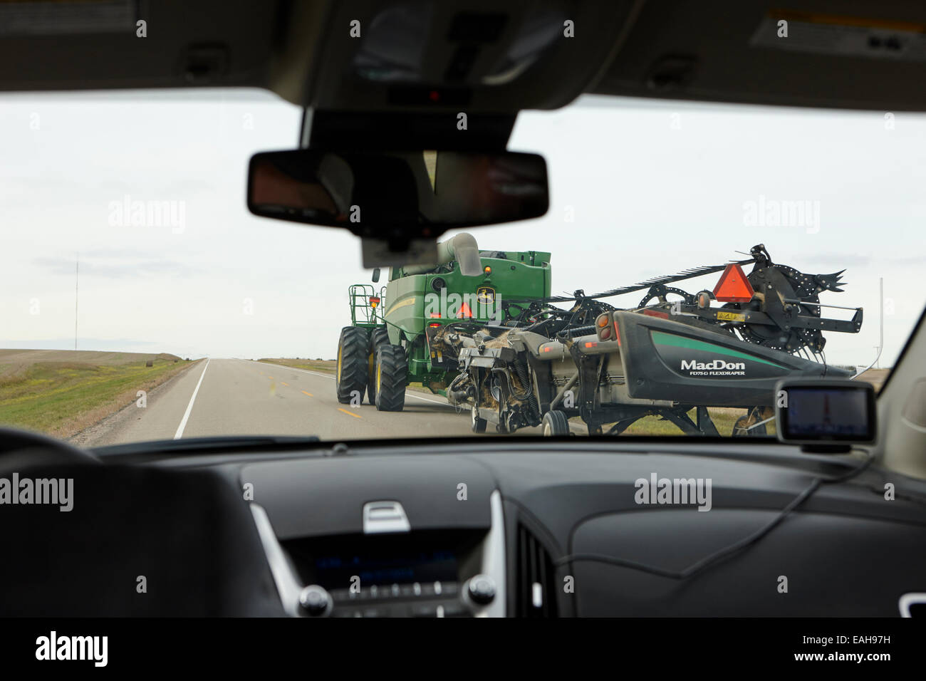 driving behind combine harvester on road in Saskatchewan Canada Stock ...