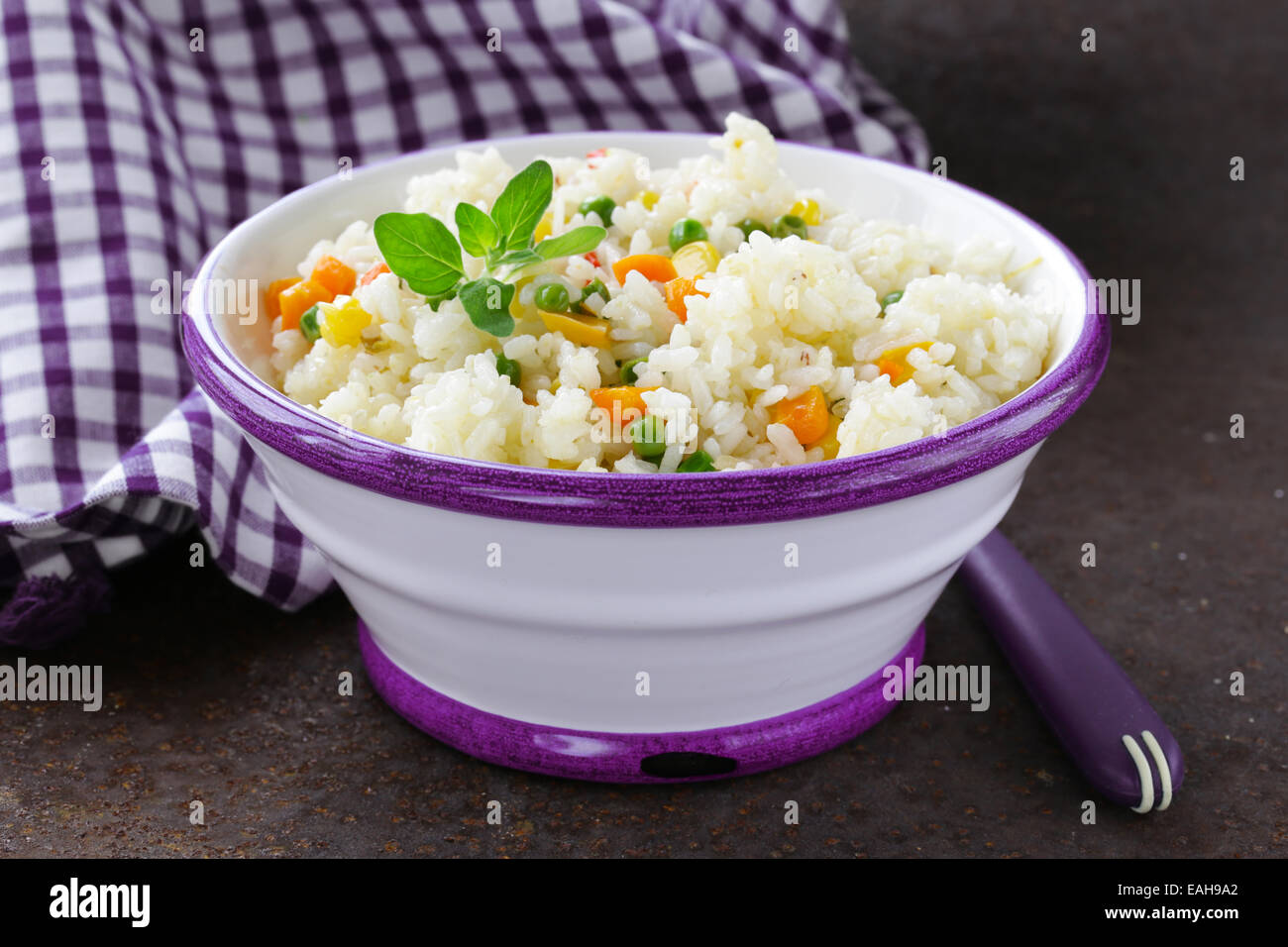 garnish rice with various vegetables (carrots, corn and green peas ...