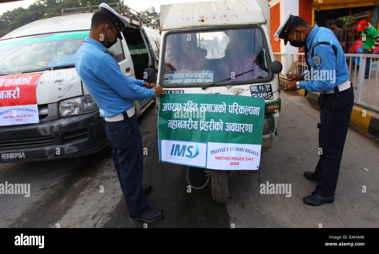 Kathmandu, Nepal. 15th Nov, 2014. Traffic police hangs a traffic ...