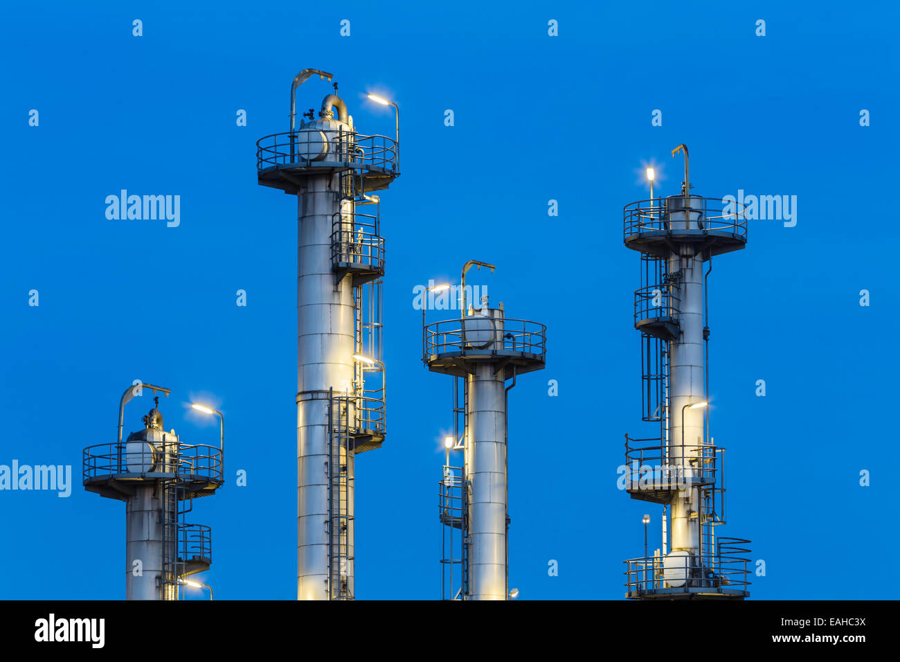 Detail of four distillation towers in a chemical plant and refinery ...