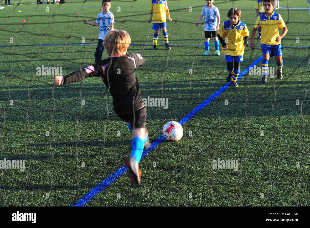 Boy kicking football outdoors hi-res stock photography and images - Alamy
