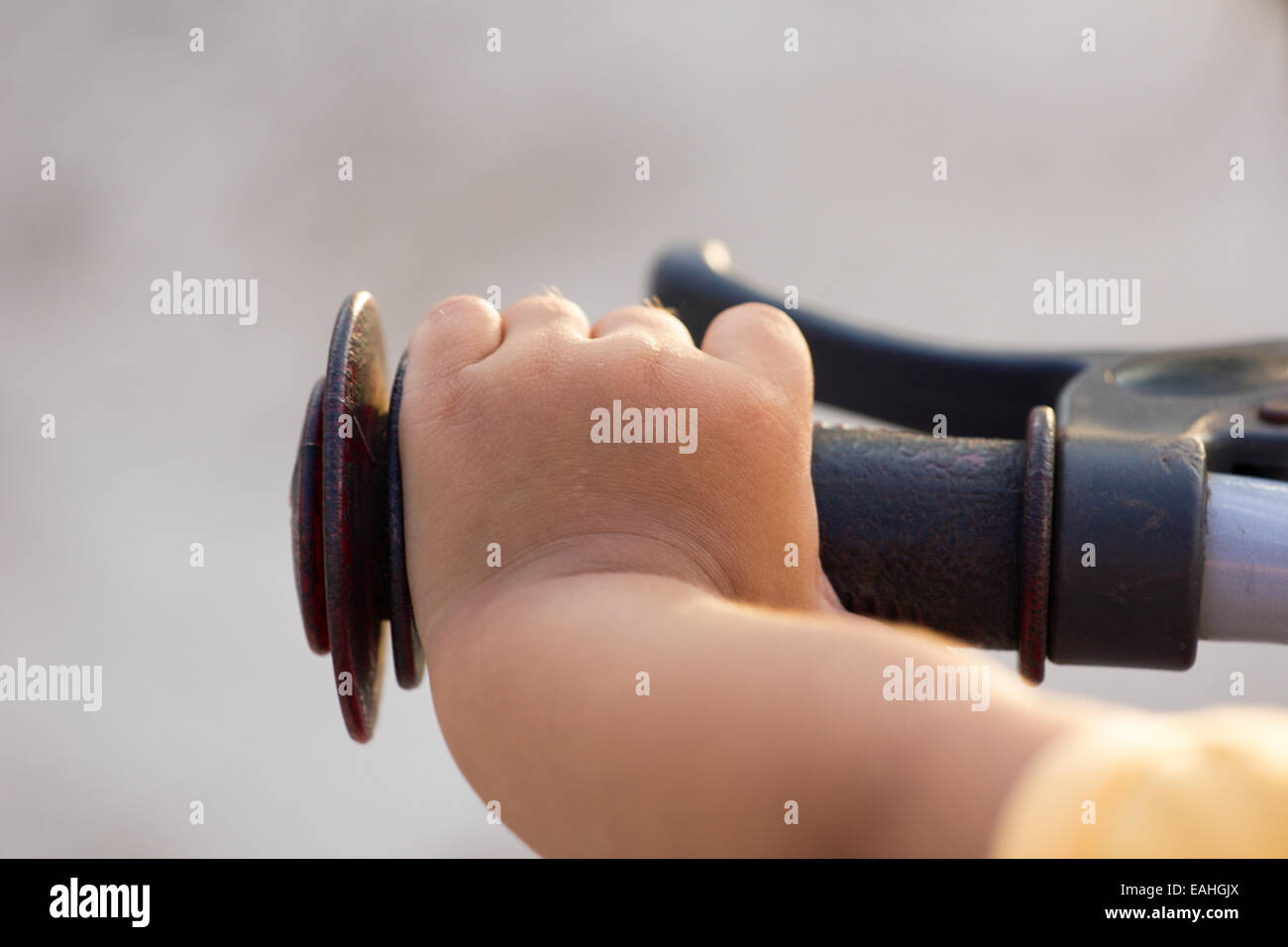 Hand's little girl and bicycle handlebar Stock Photo - Alamy