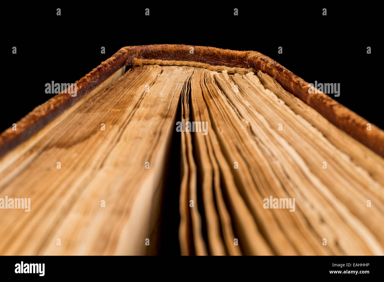ancient book shot on black background. The book is in bad condition ...