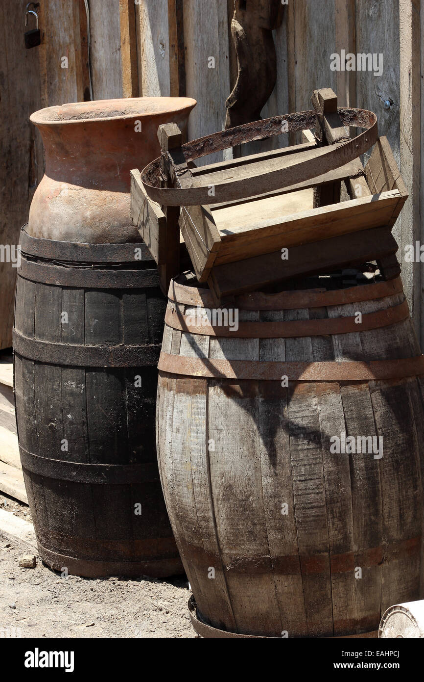Vintage wooden barrels and ceramic pots next to a wall in Cotacachi ...