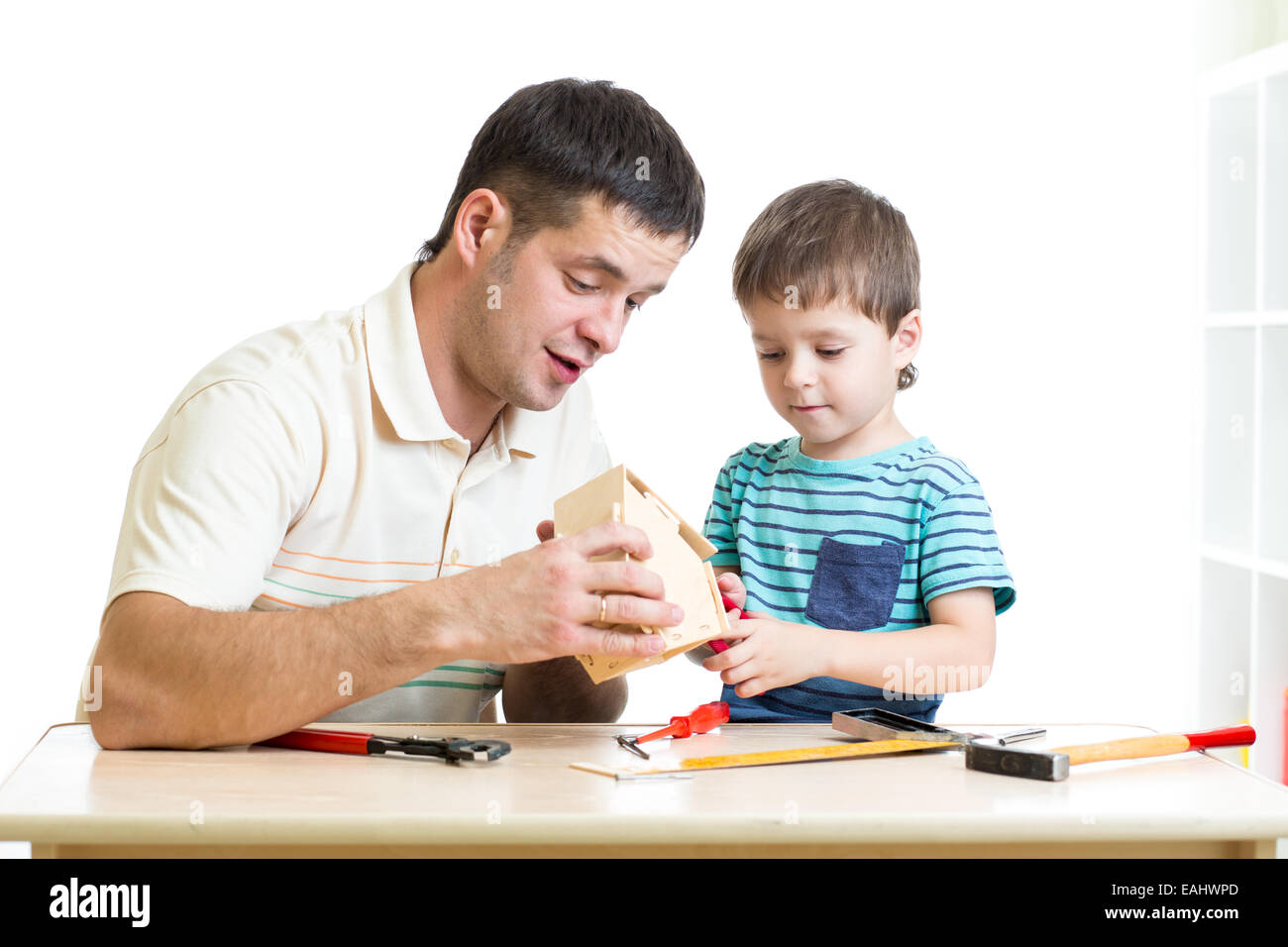 Dad and son kid work with building tools Stock Photo - Alamy