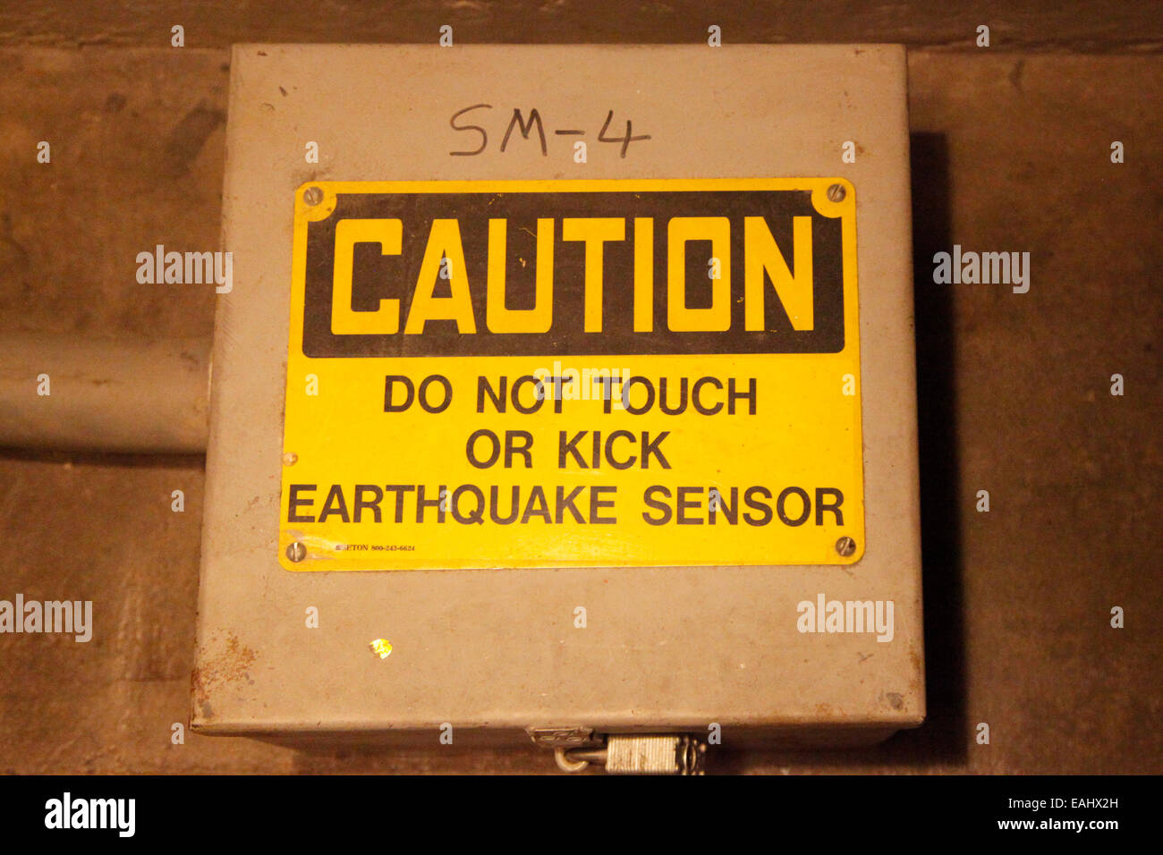 Caution sign near earthquake sensor inside Hoover Dam Stock Photo - Alamy