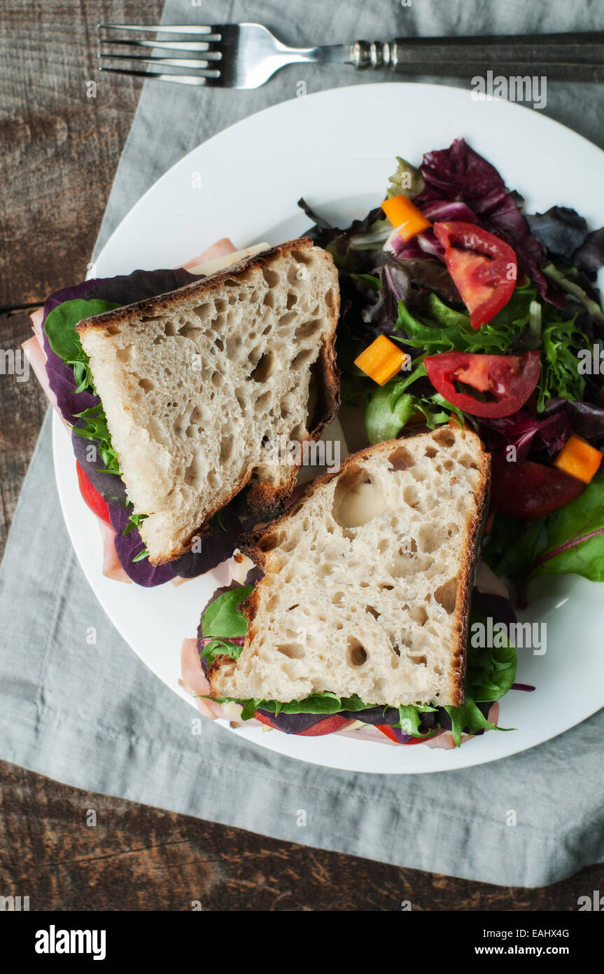 Thin sliced ham and vegetables on rustic crusty fresh country bread ...