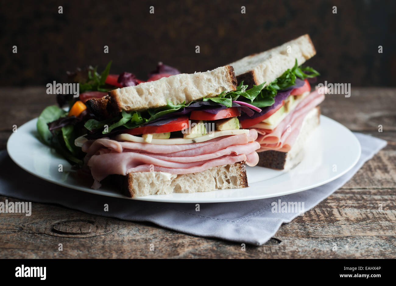 Thin sliced ham and vegetables on rustic crusty fresh country bread ...