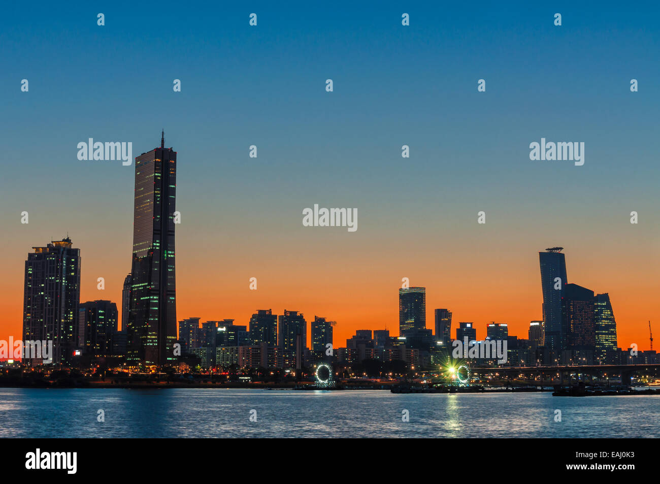 The sun sets behind the skyscrapers of Seoul, South Korea Stock Photo ...