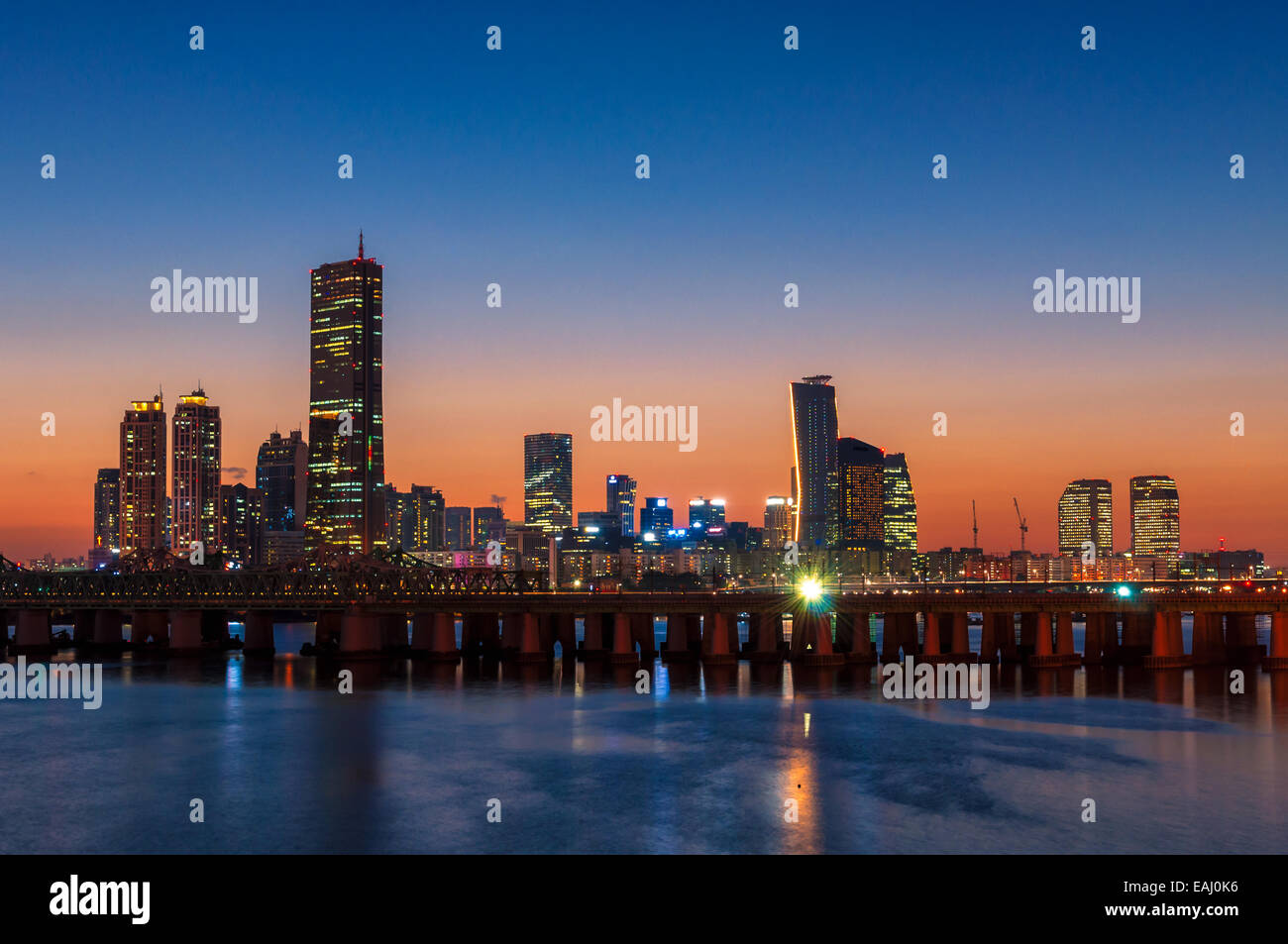 The sun sets behind the skyscrapers of Seoul, South Korea Stock Photo ...