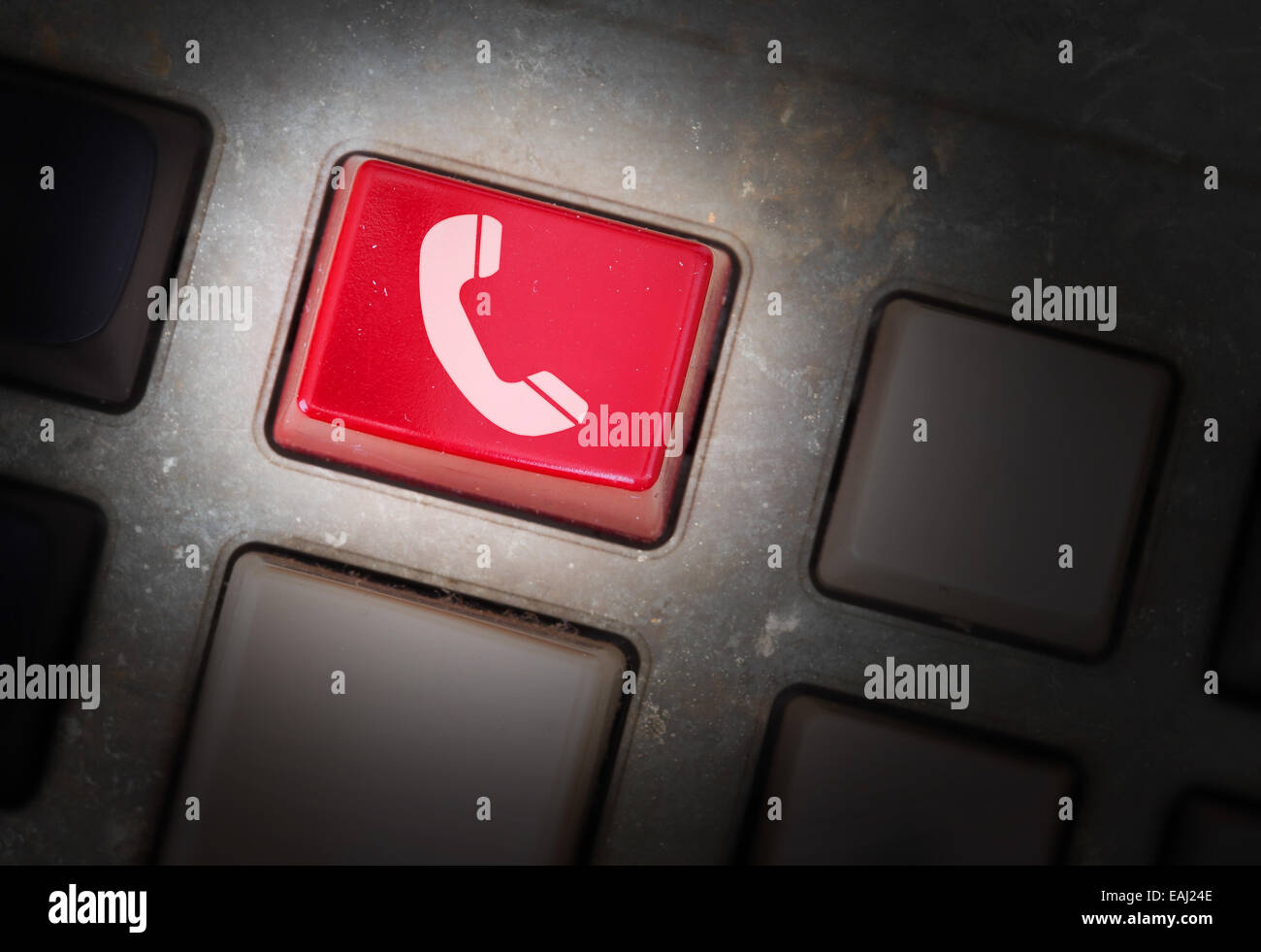 Red button on a dirty old panel, selective focus - telephone symbol ...