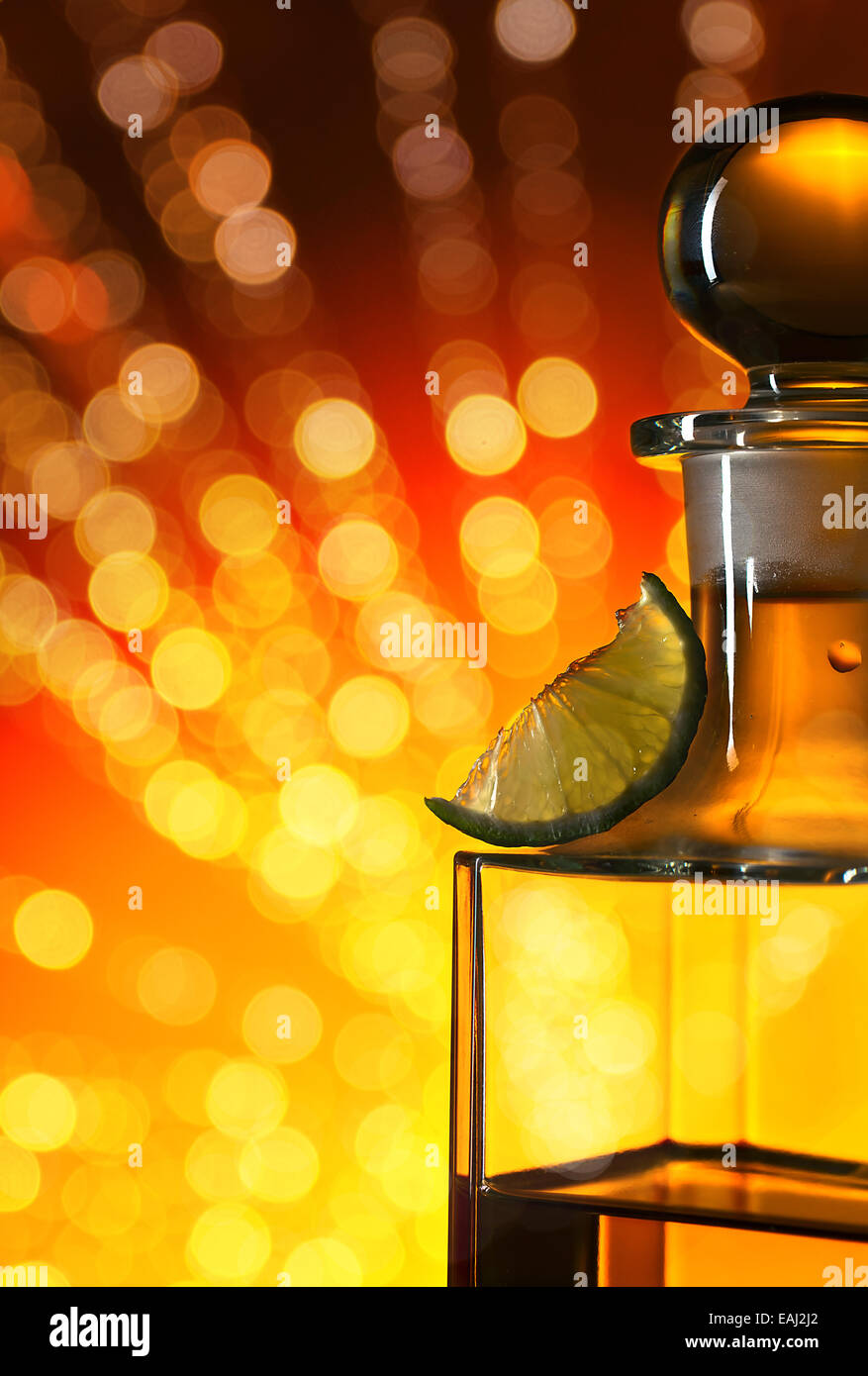 carafe with gold tequila and slice of lime Stock Photo - Alamy