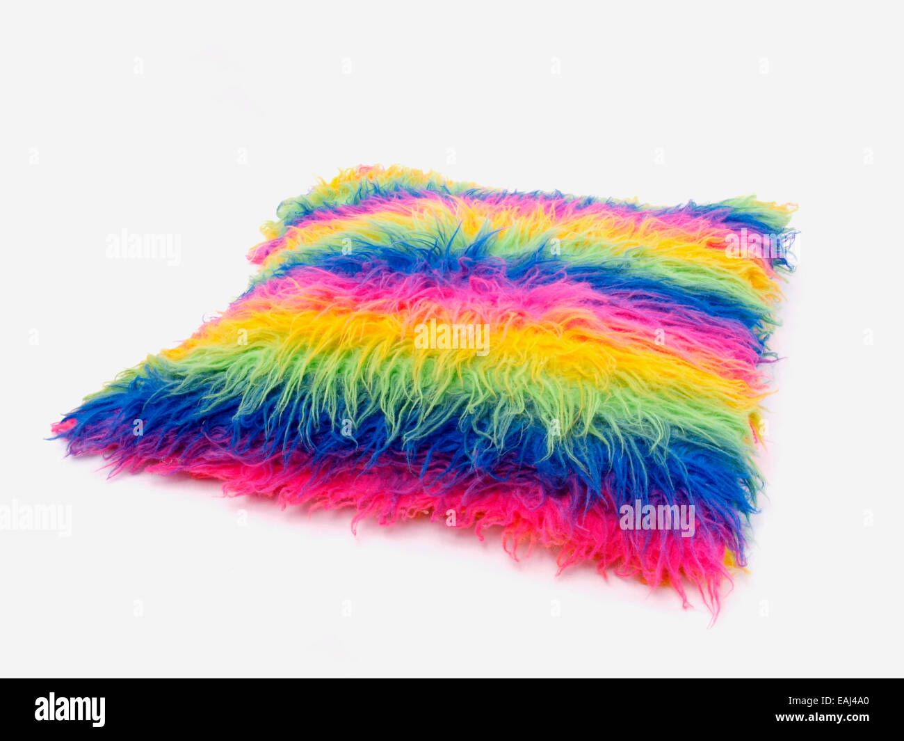 Fluffy rainbow coloured cushion on a white background Stock Photo - Alamy
