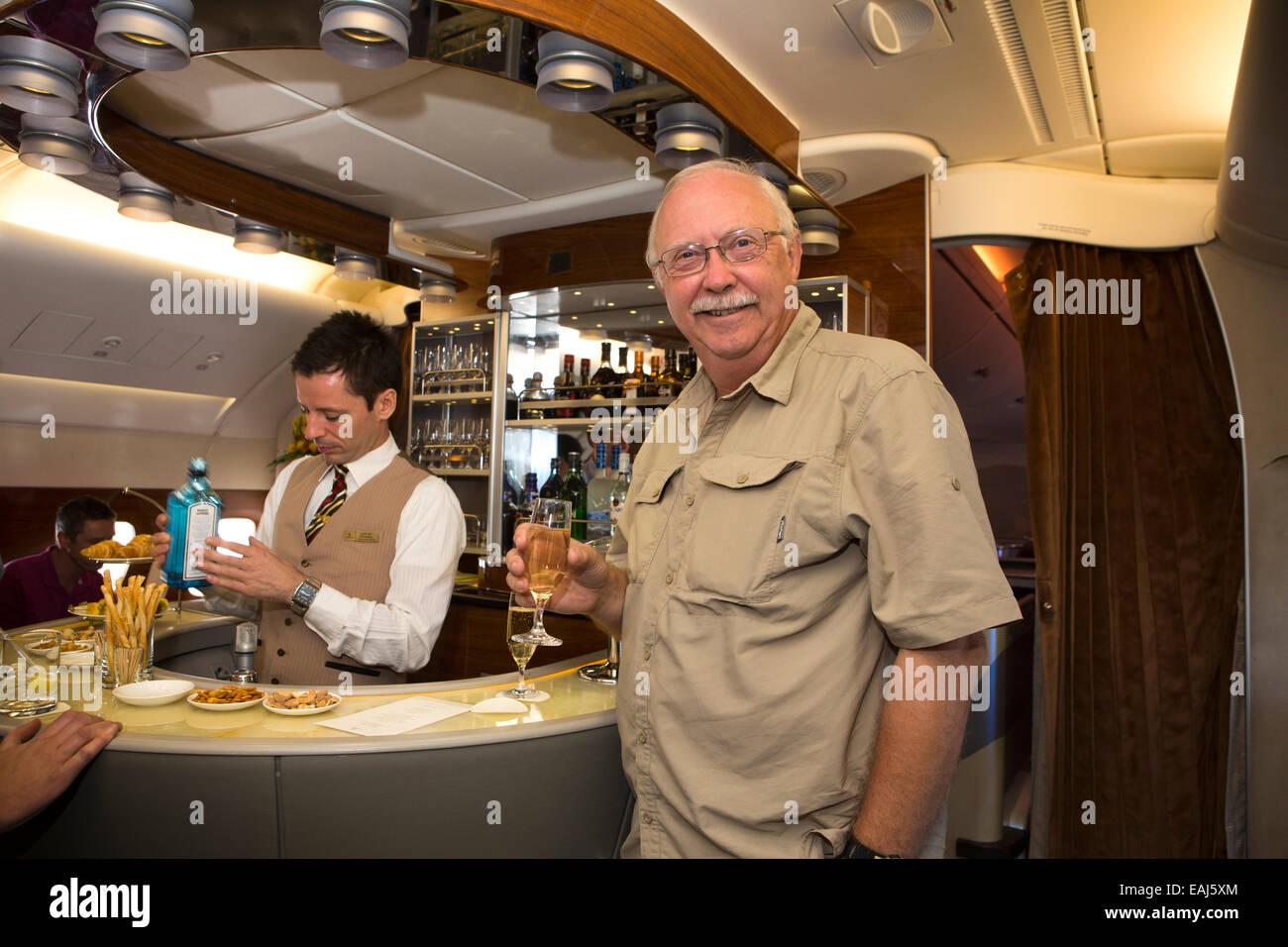 Emirates Airline, male passenger with champagne in bar of A380 Business ...