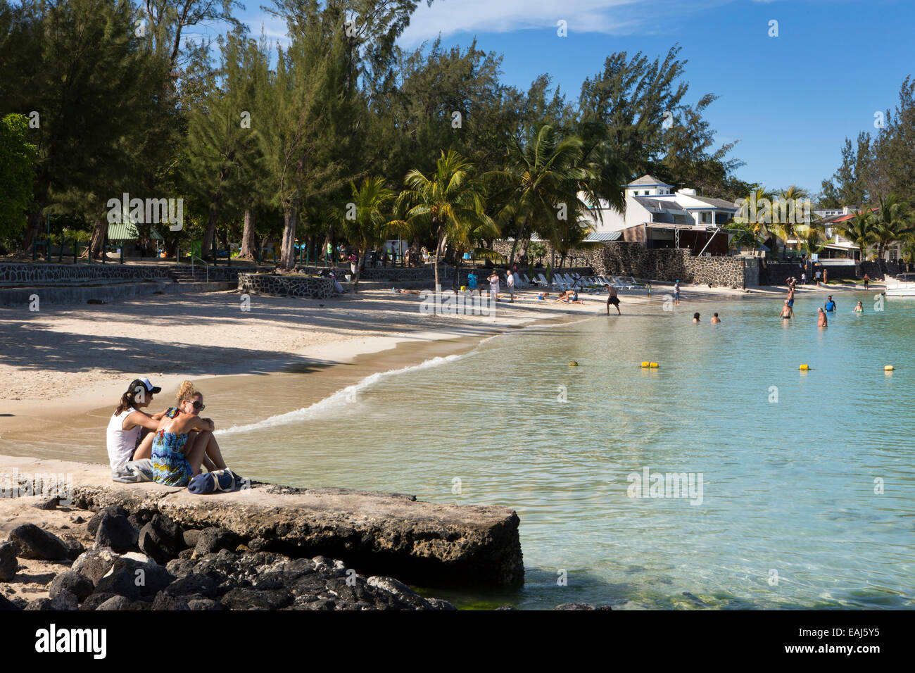 Mauritius, Pereybere, public beach, visitors sat in sunshine, on ...