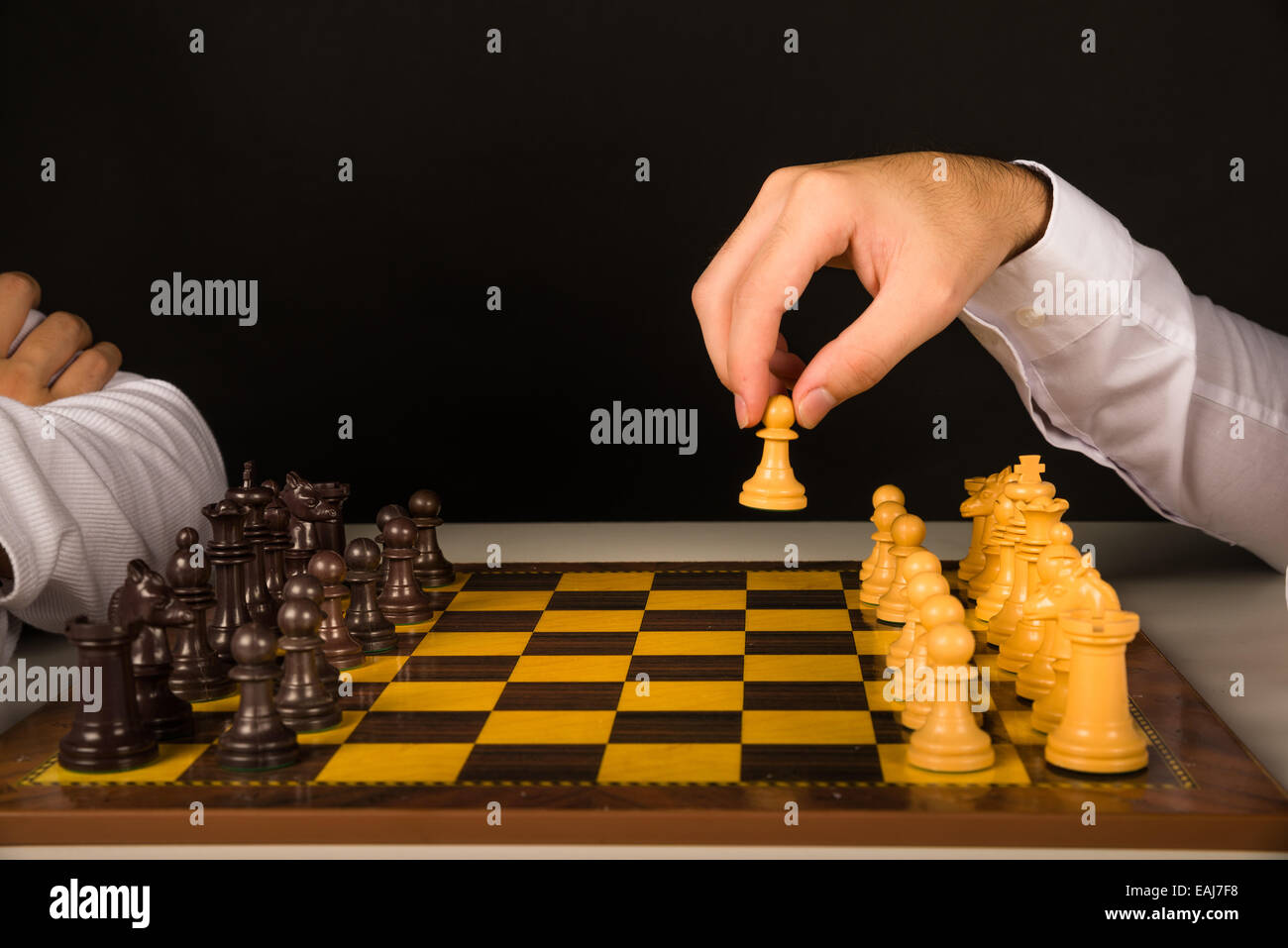 Male hand holding chess pawn, about to begin the game Stock Photo - Alamy