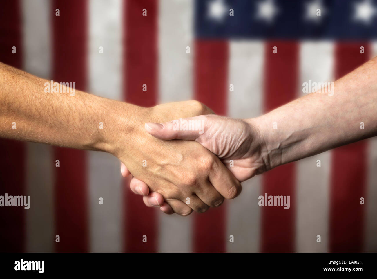 Closeup of people shaking hands over a USA flag Stock Photo - Alamy