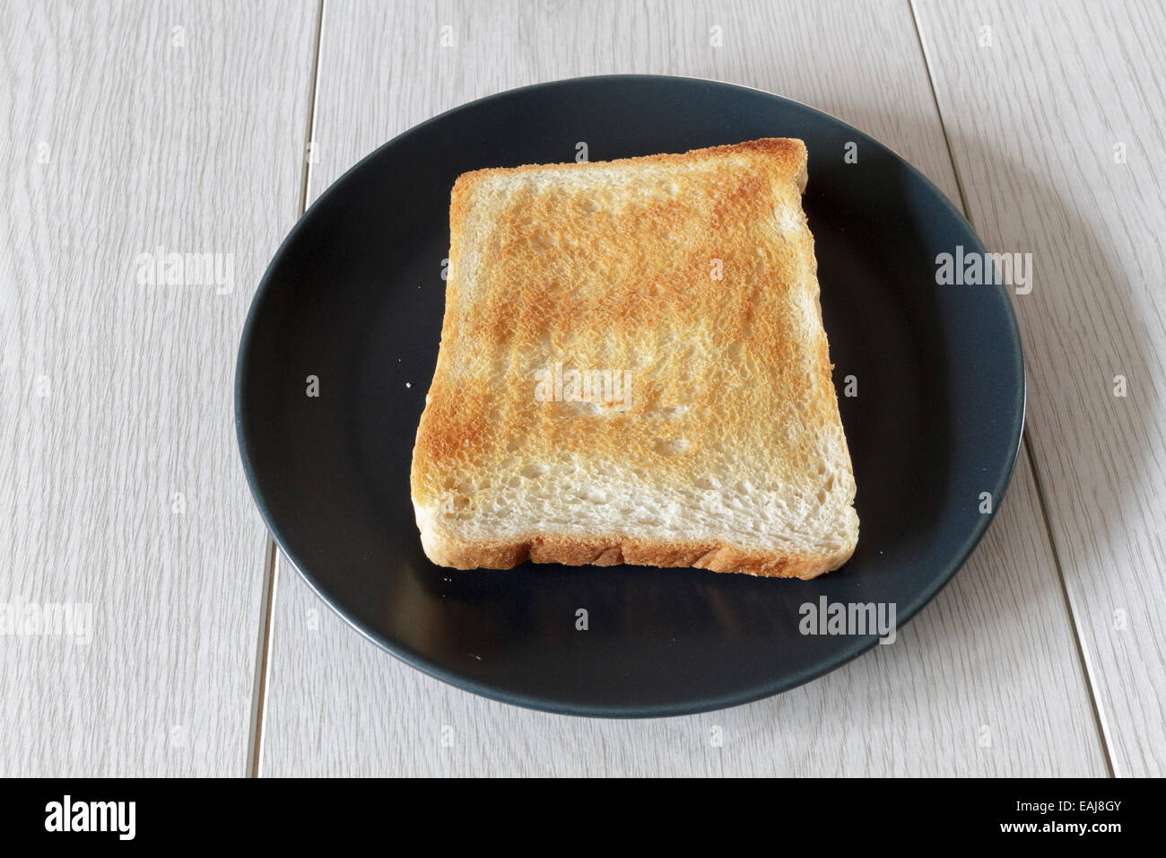 Piece of dry toast on a plate Stock Photo - Alamy