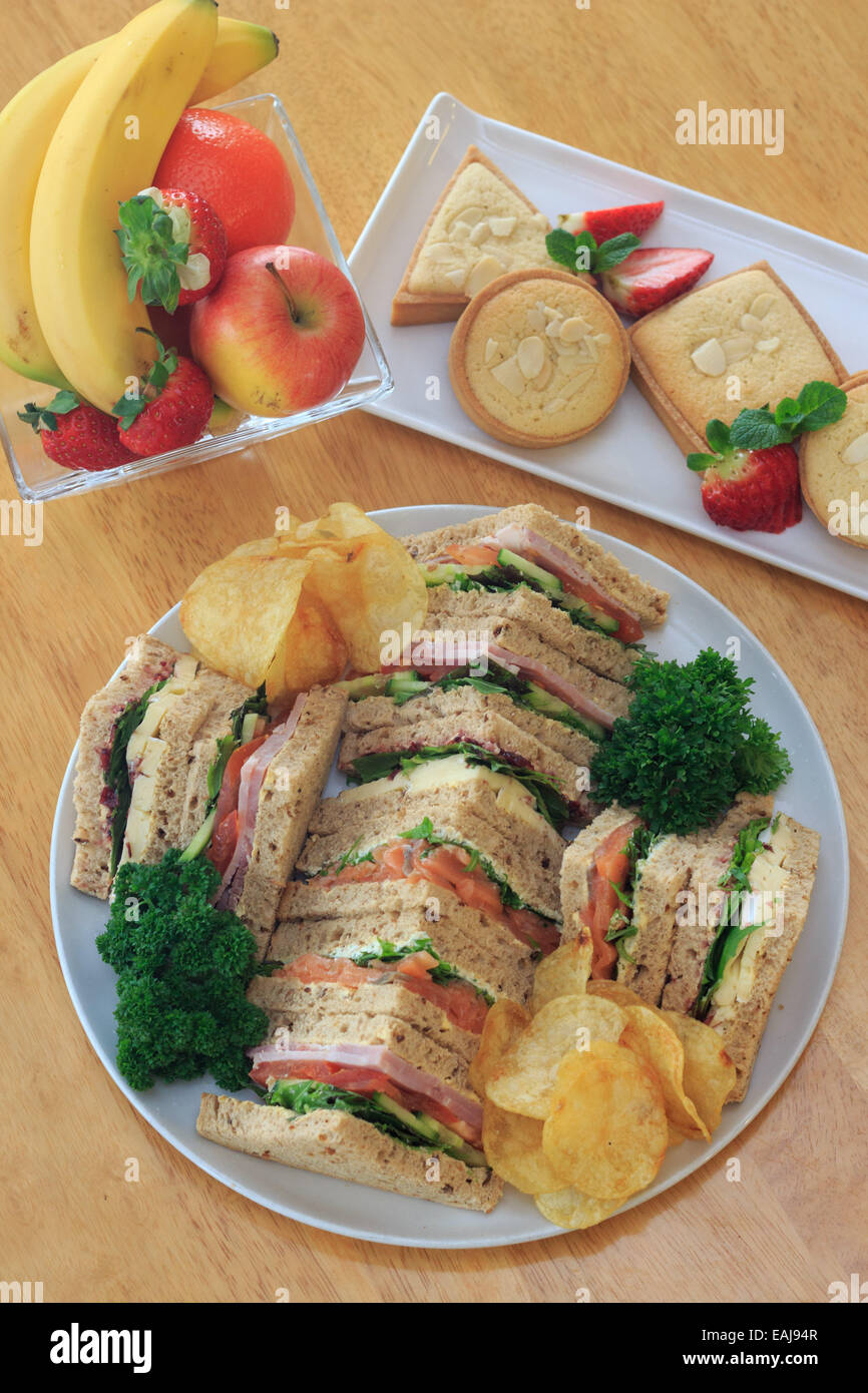 plated buffet lunch with a selection of sandwiches fruit baked sweets ...