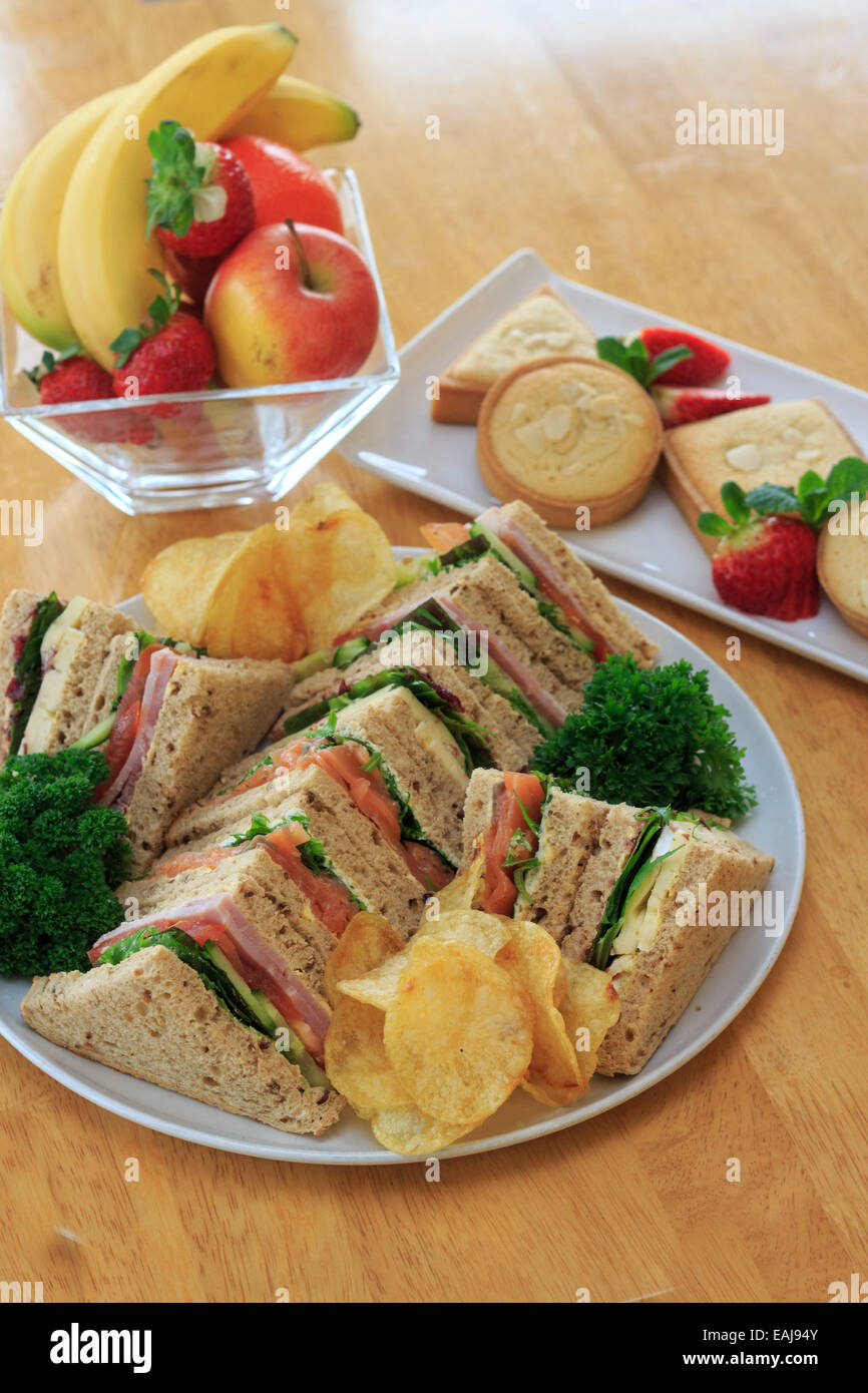 plated buffet lunch with a selection of sandwiches fruit baked sweets ...