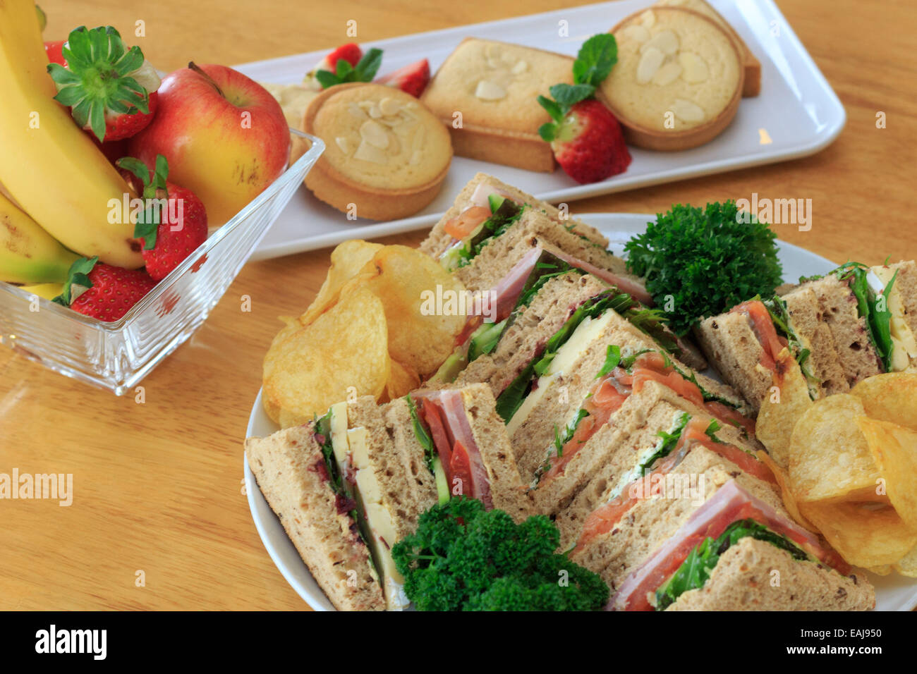 plated buffet lunch with a selection of sandwiches fruit baked sweets ...