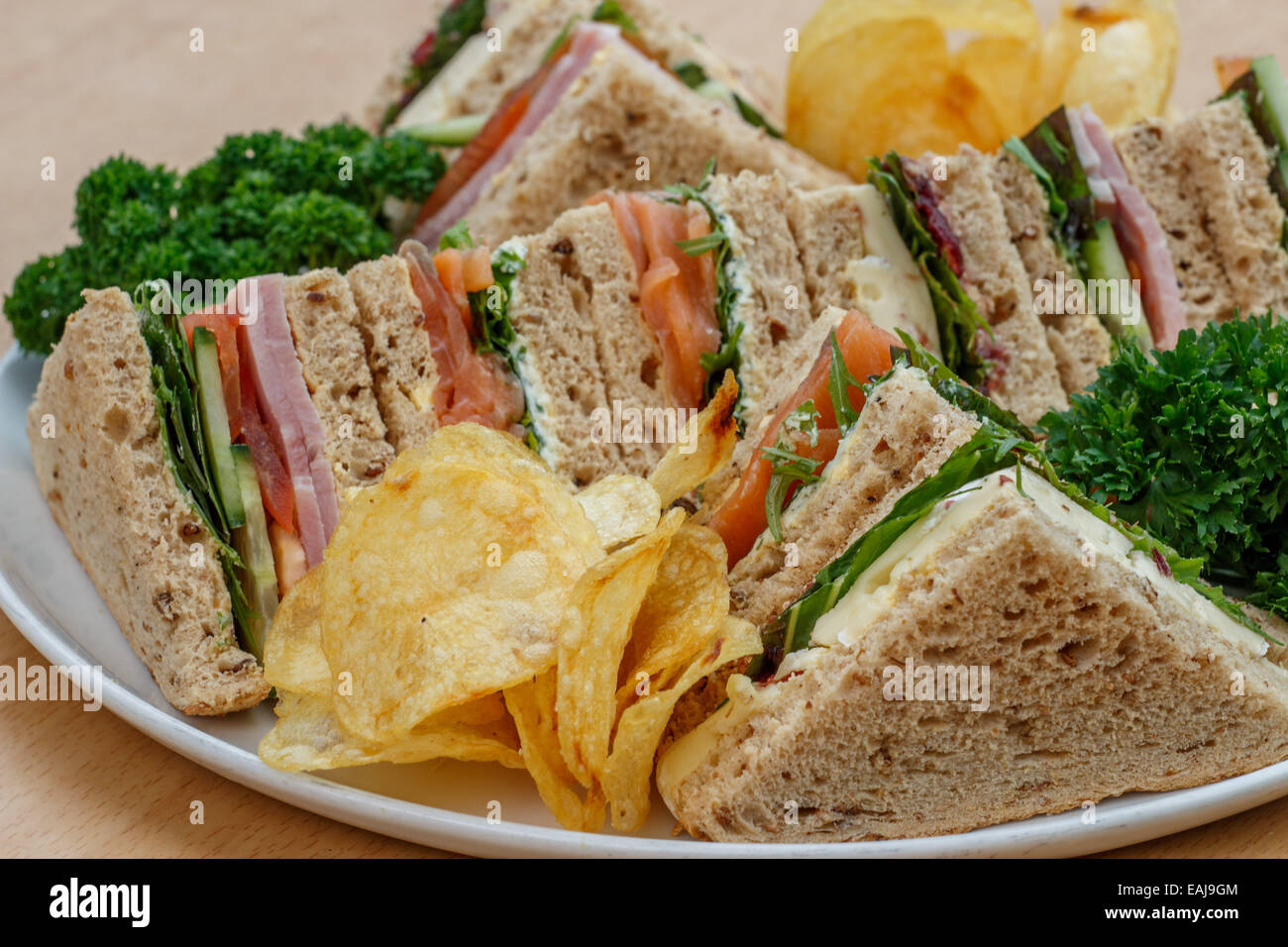 plated buffet lunch with a selection of sandwiches fruit baked sweets ...
