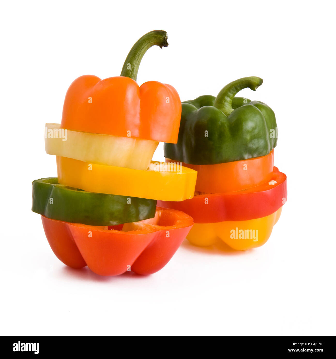 Mixed pieces of different colored paprikas isolated on white Stock ...