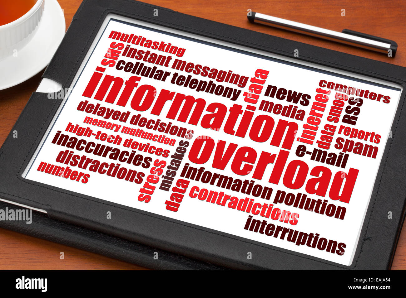 information overload concept - word cloud on a digital tablet with a ...