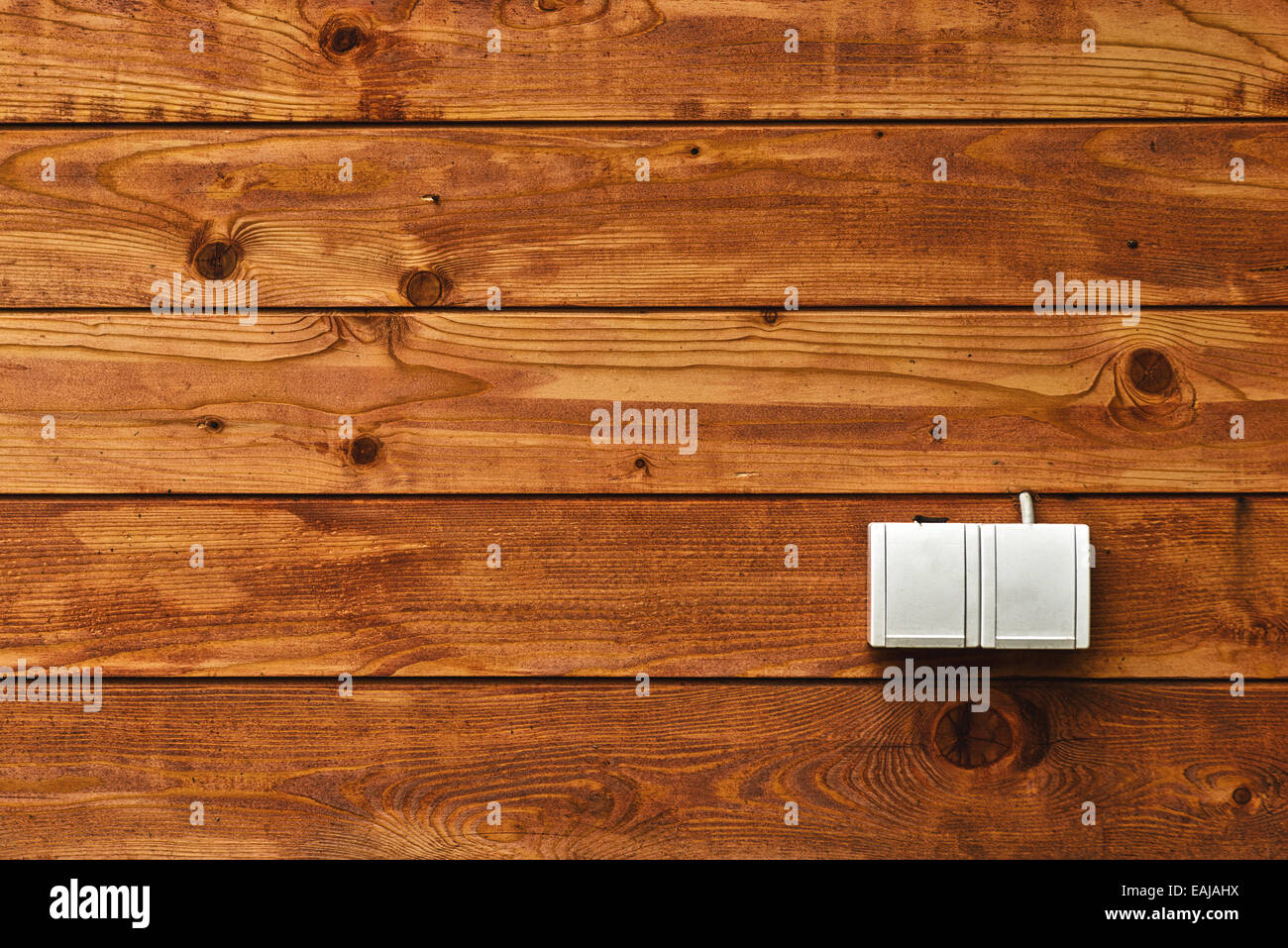 Plastic AC Electricity Power Sockets with cover on wooden wall as ...