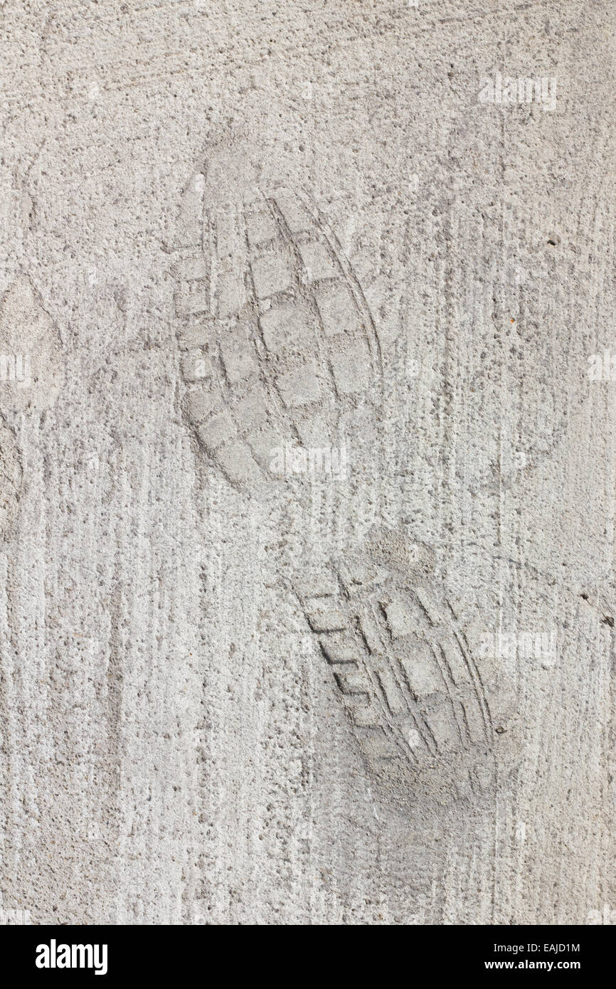 Man footprints on concrete track Stock Photo - Alamy