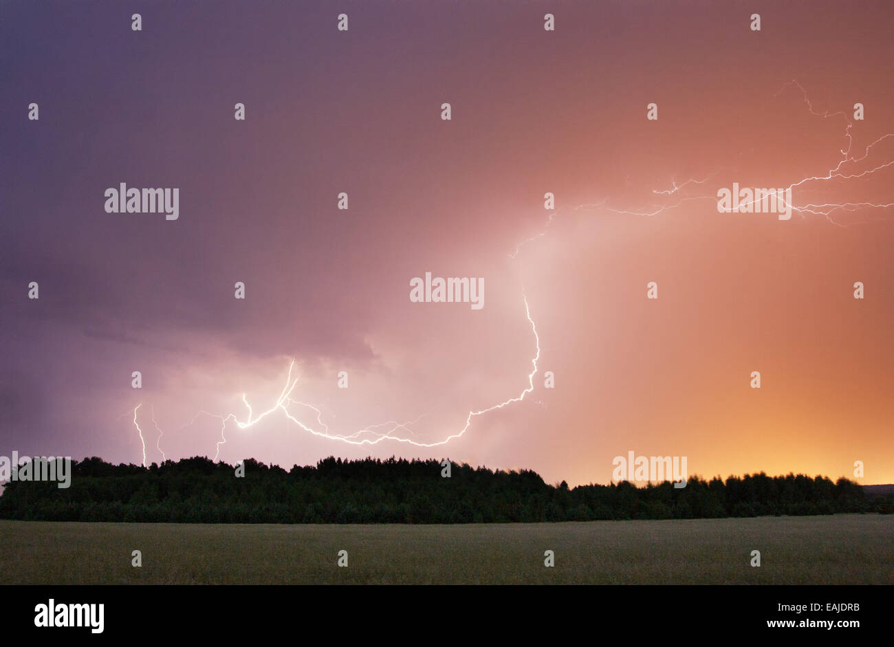 Thunderbolt and storm clouds over field. Summer storm landscape Stock ...