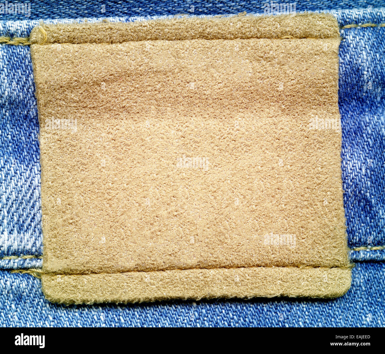 Jeans texture with leather label Stock Photo - Alamy