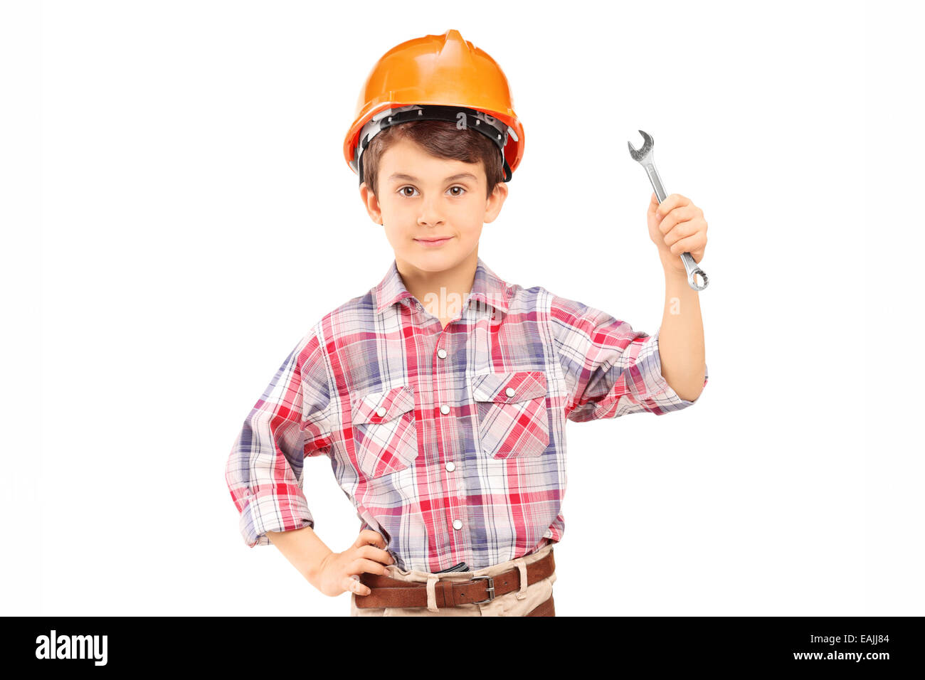 Cute little boy wearing working clothes and holding a wrench isolated ...