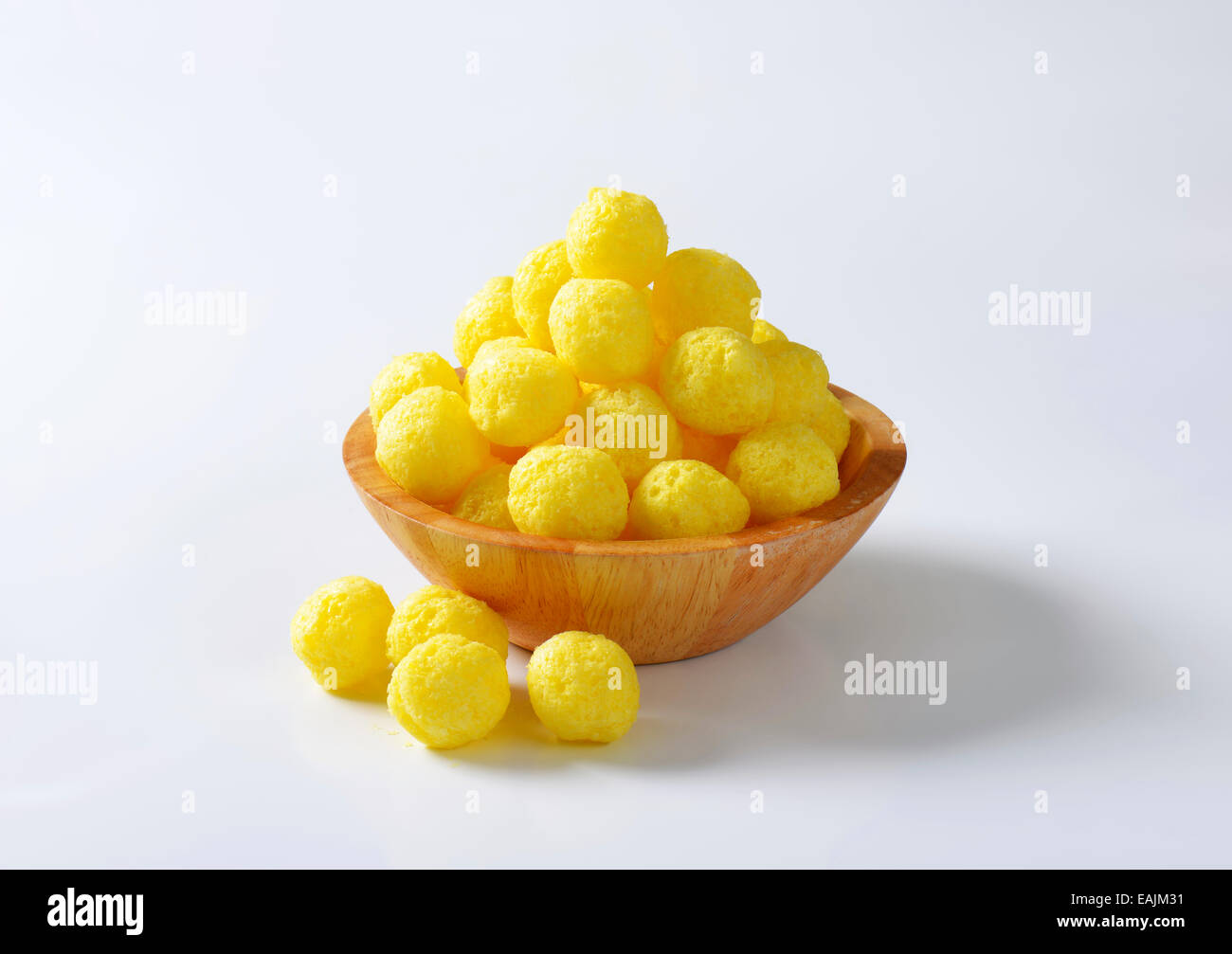 Puffed snack - Cereal balls in wooden bowl Stock Photo - Alamy
