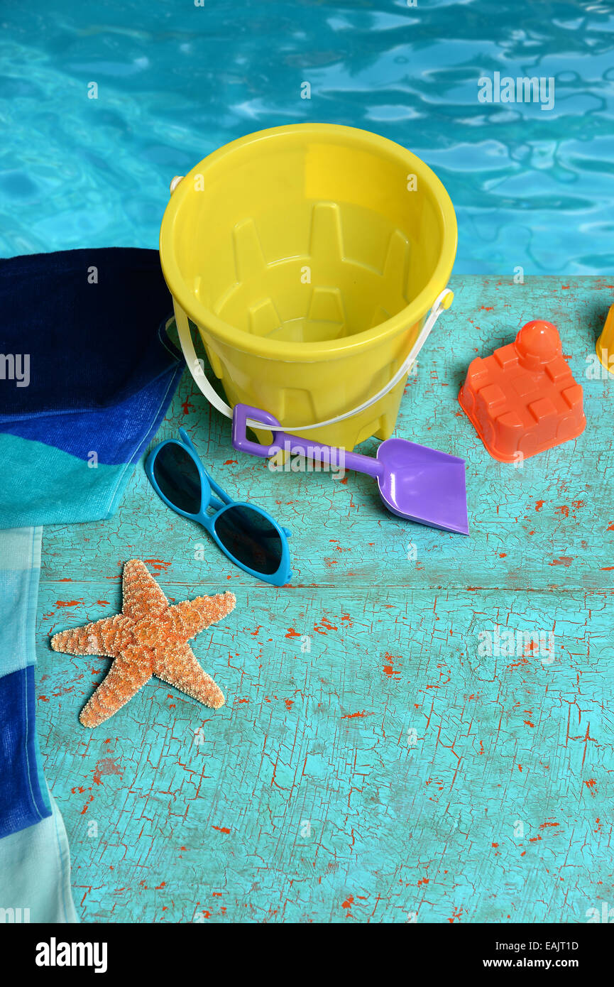 Beach objects on wood planks near clear water Stock Photo - Alamy