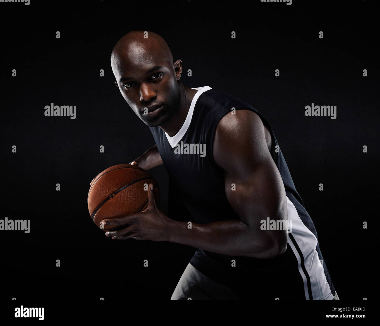 Portrait of fit young male athlete playing basketball. African American ...