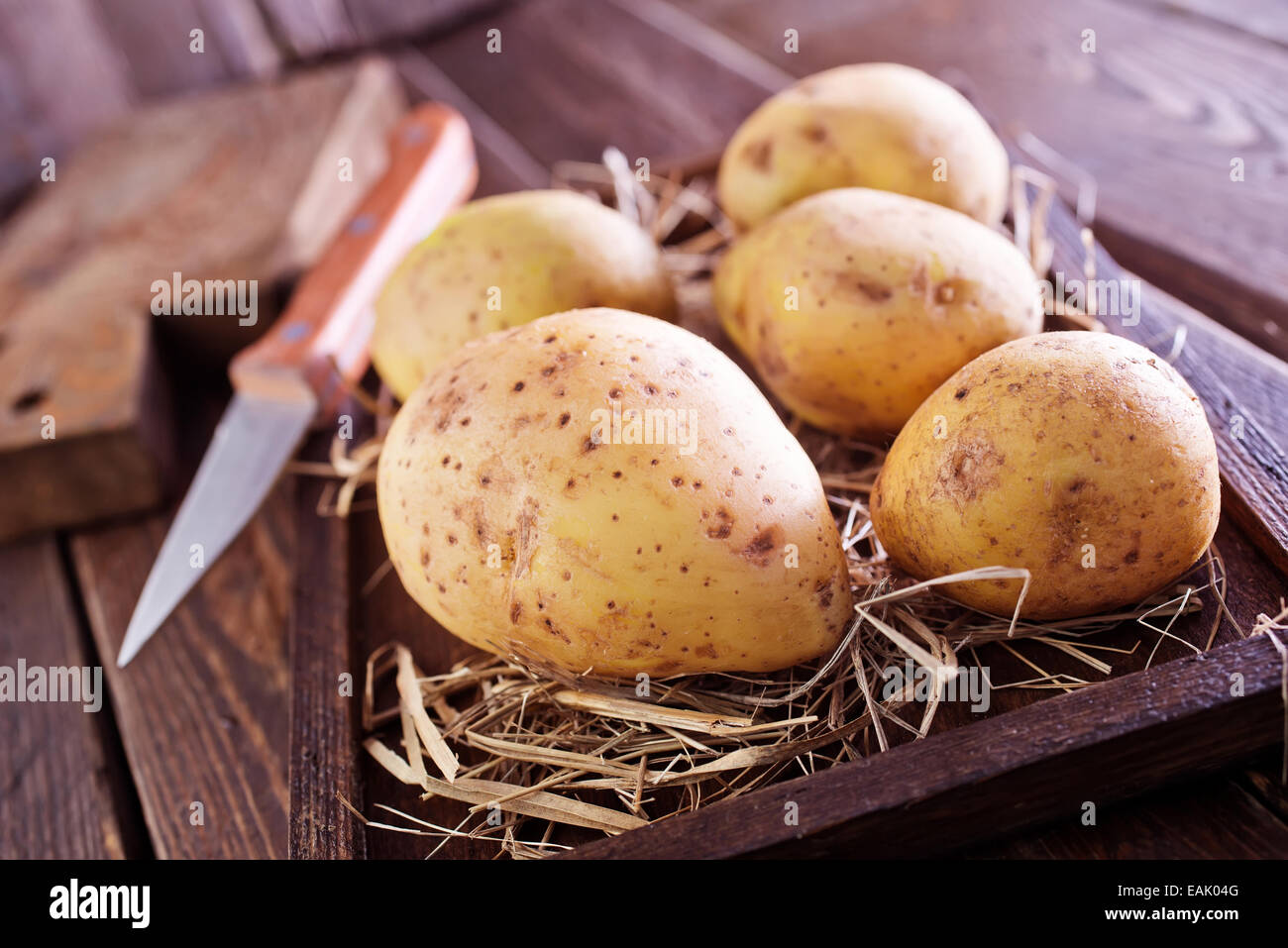 raw potato in wooden box and on a table Stock Photo - Alamy