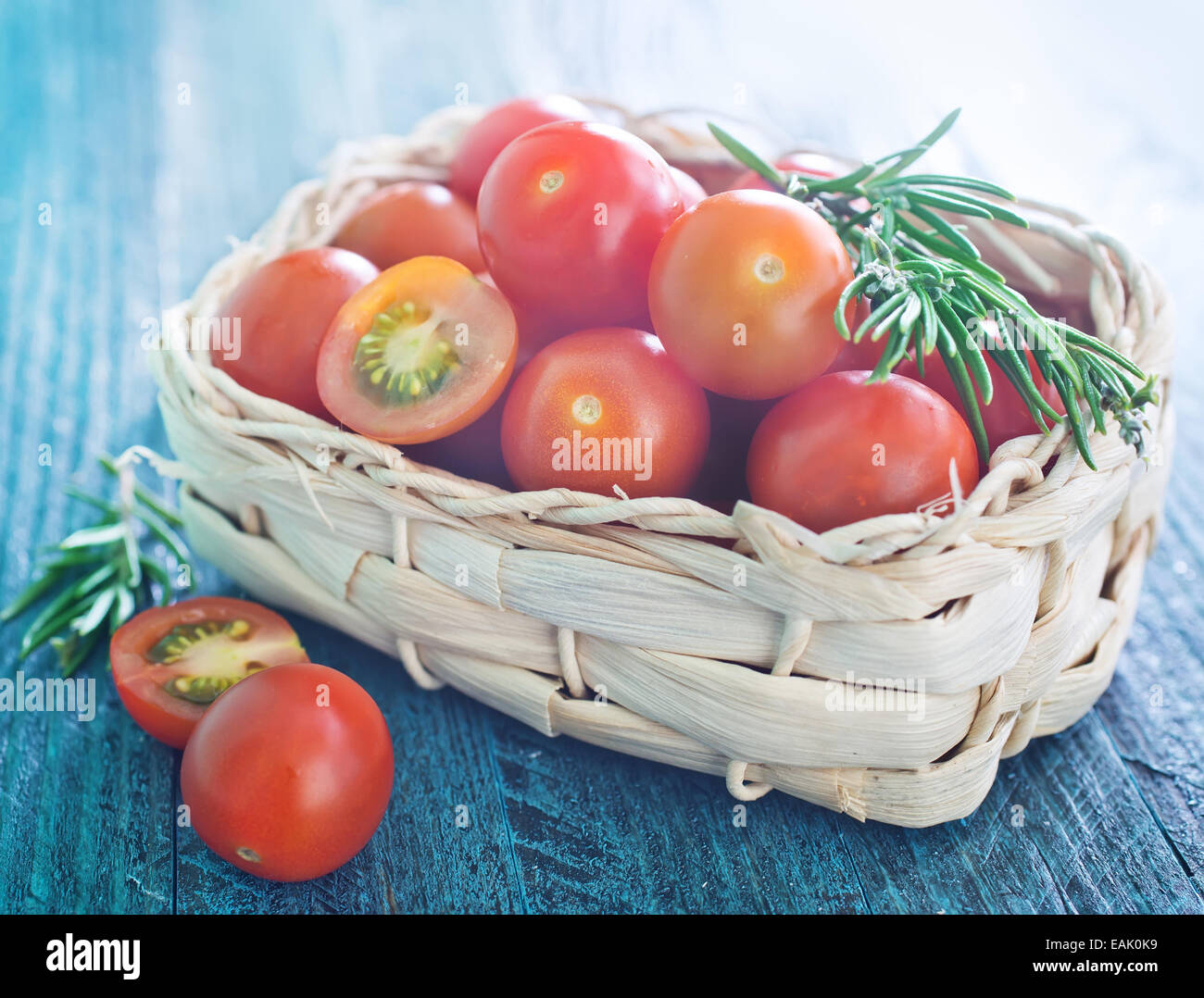 fresh tomato cherry in basket and on a table Stock Photo - Alamy