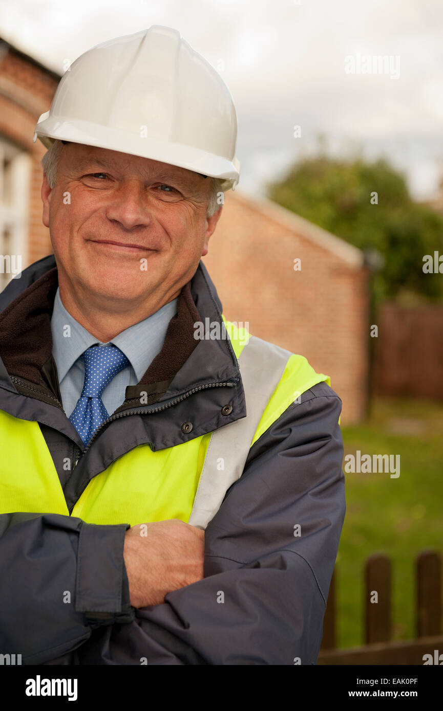 Outdoors portrait of a civil engineer wearing a white safety helmet ...