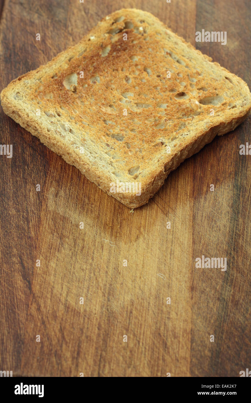 Toast on brown chopping board Stock Photo - Alamy