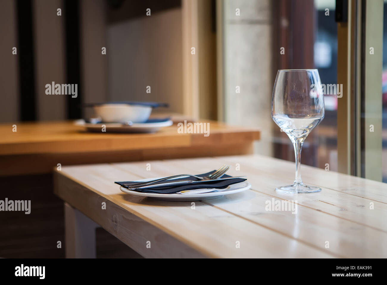 restaurant table set with plate and empty cup Stock Photo - Alamy