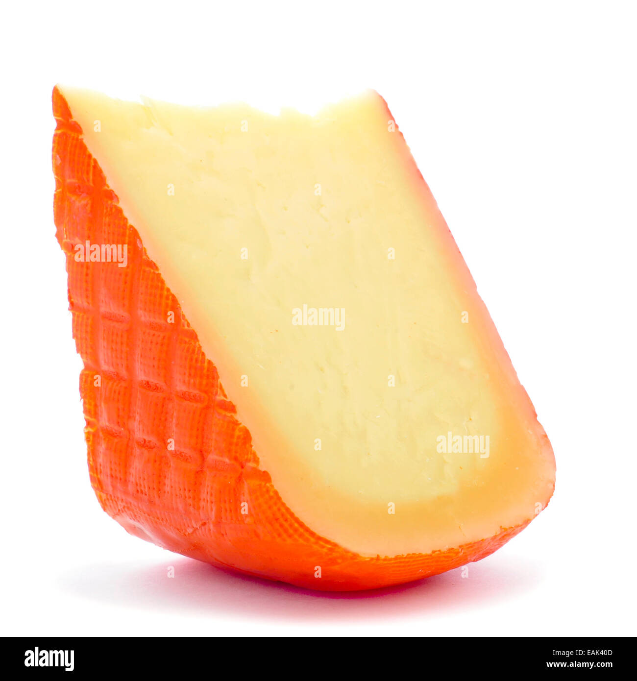 closeup of a piece of Mahon cheese from Spain, on a white background ...