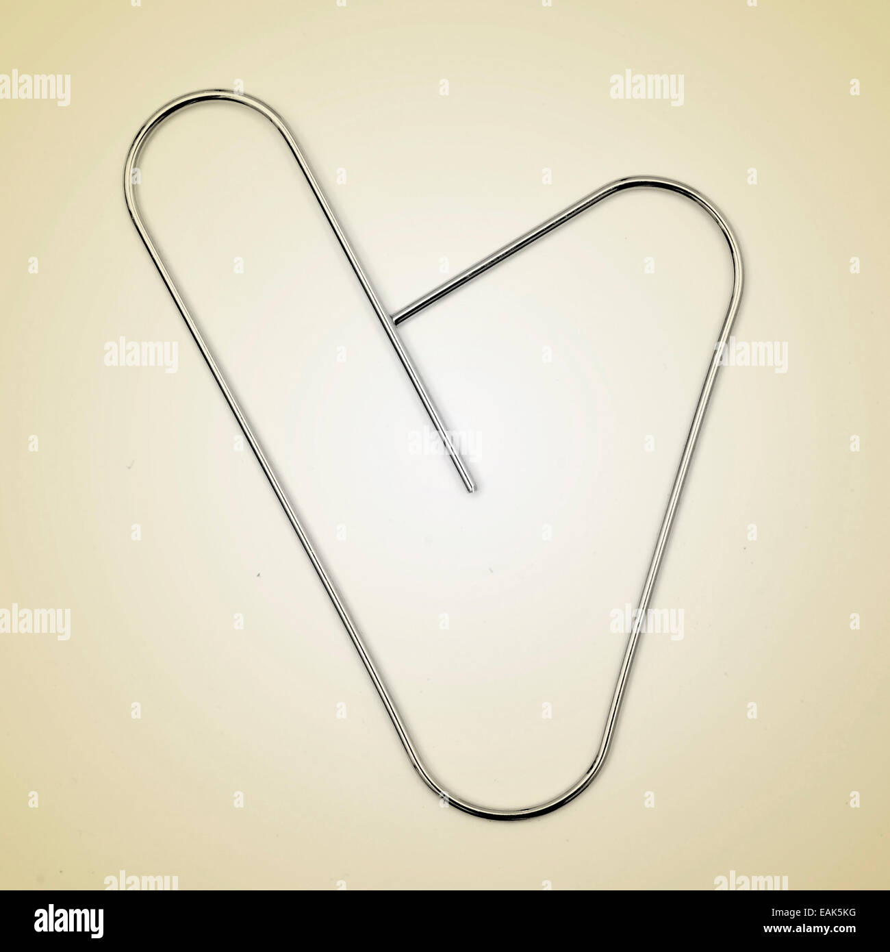 picture of a heart-shaped paperclip on a beige background, with a retro ...