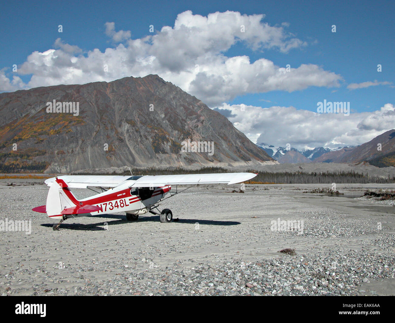 A Piper Super Cub bush plane along a river bed in the Yakutat District ...
