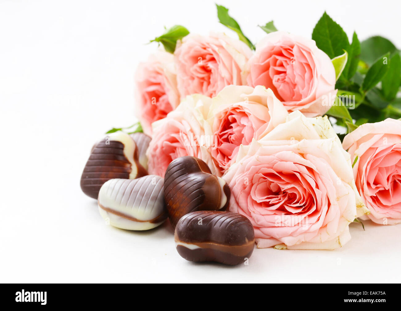 chocolate candy in the shape of hearts and pink roses for Valentine's ...
