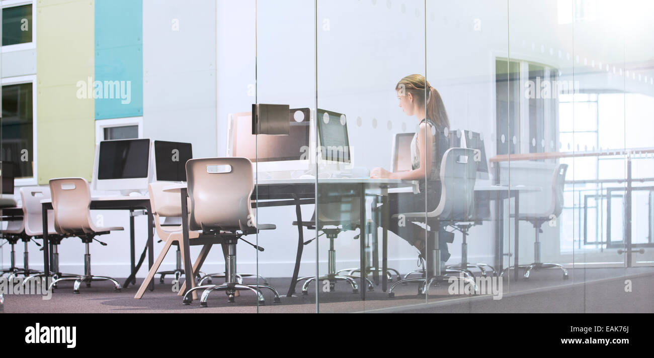 Teenage girl using computer in computer room Stock Photo - Alamy