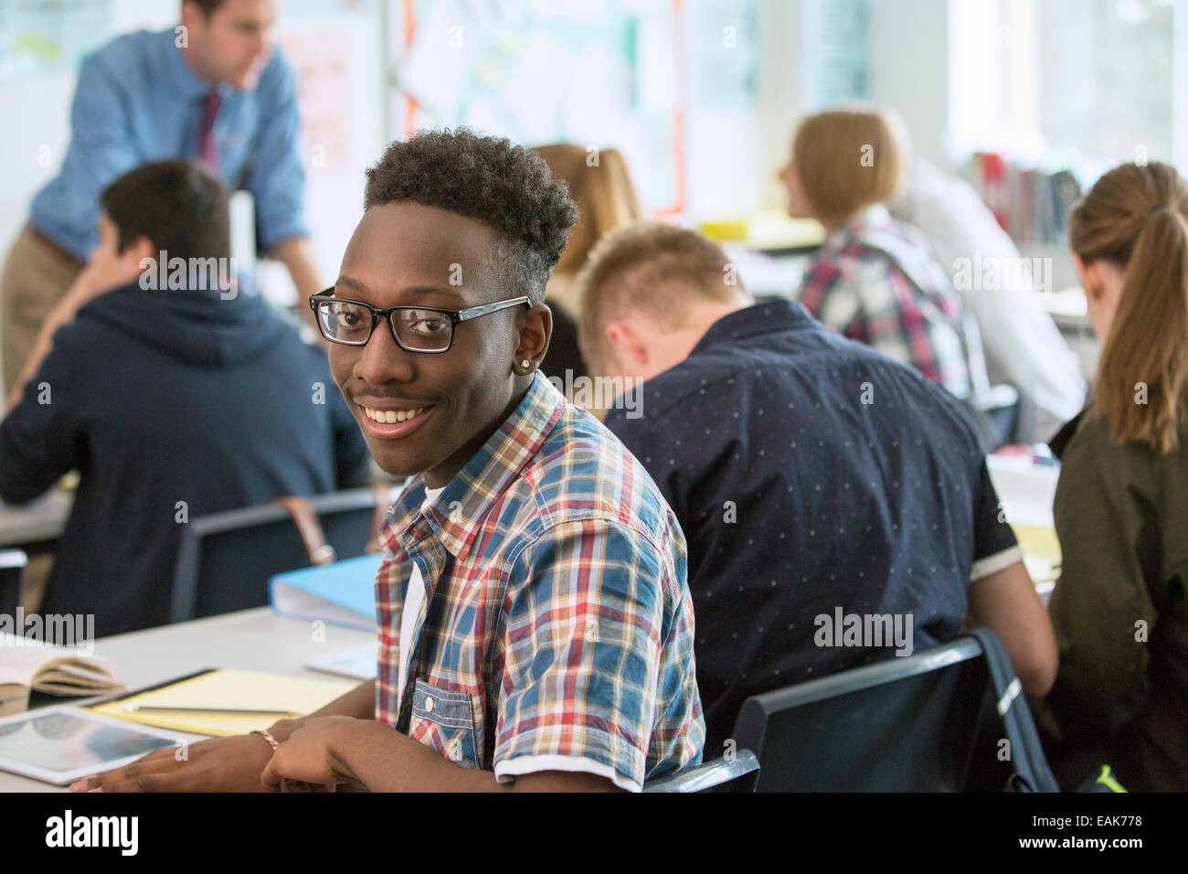 Smiling and confident students with teacher in classroom Stock Photo ...