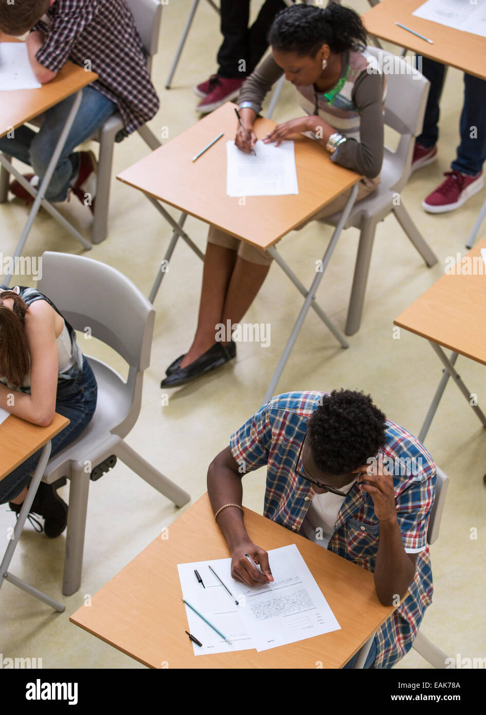 Elevated view of students writing their GCSE exam in classroom Stock ...